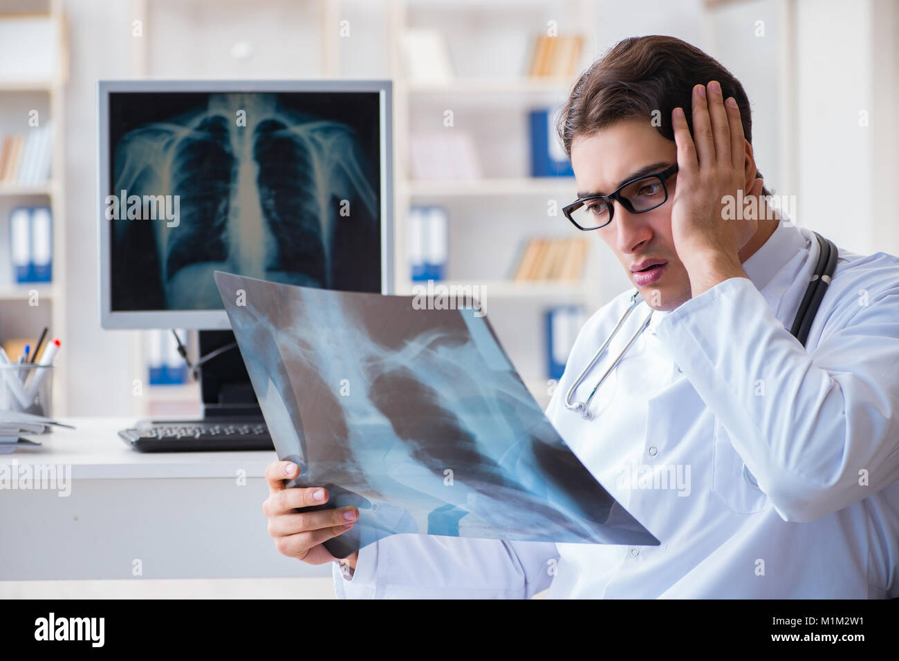 Doctor radiologist looking at x-ray images Stock Photo - Alamy