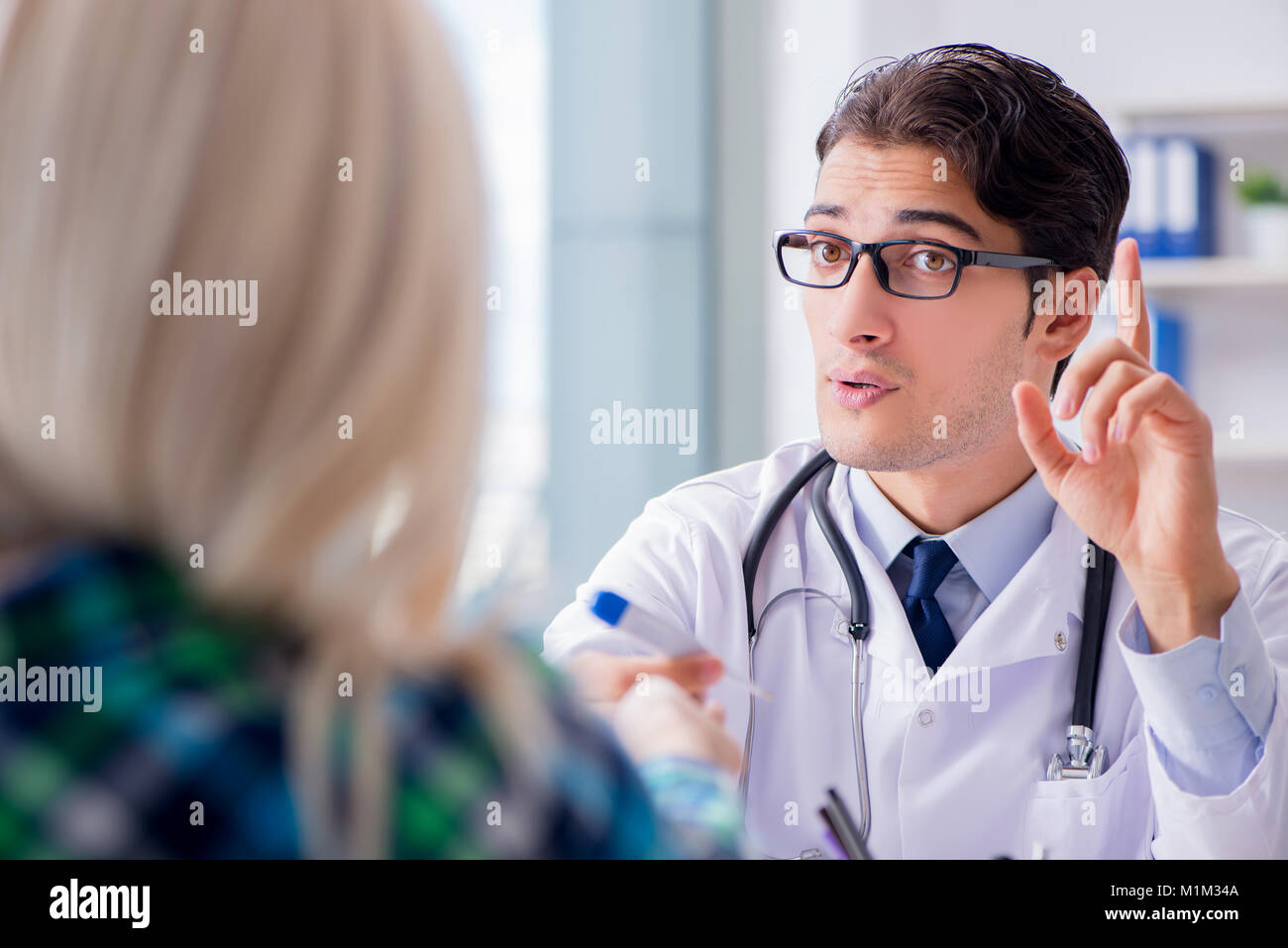 Patient visiting doctor for medical check-up in hospital Stock Photo ...