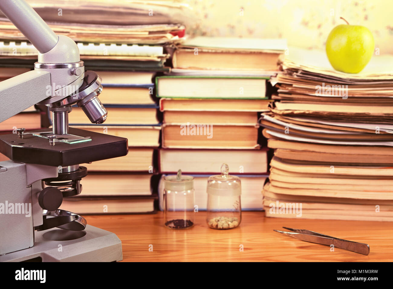 Microscope and test specimens of seed on the table with scientific ...