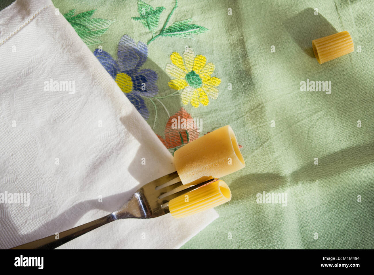 geometric composition with top view between raw pasta and silver ...