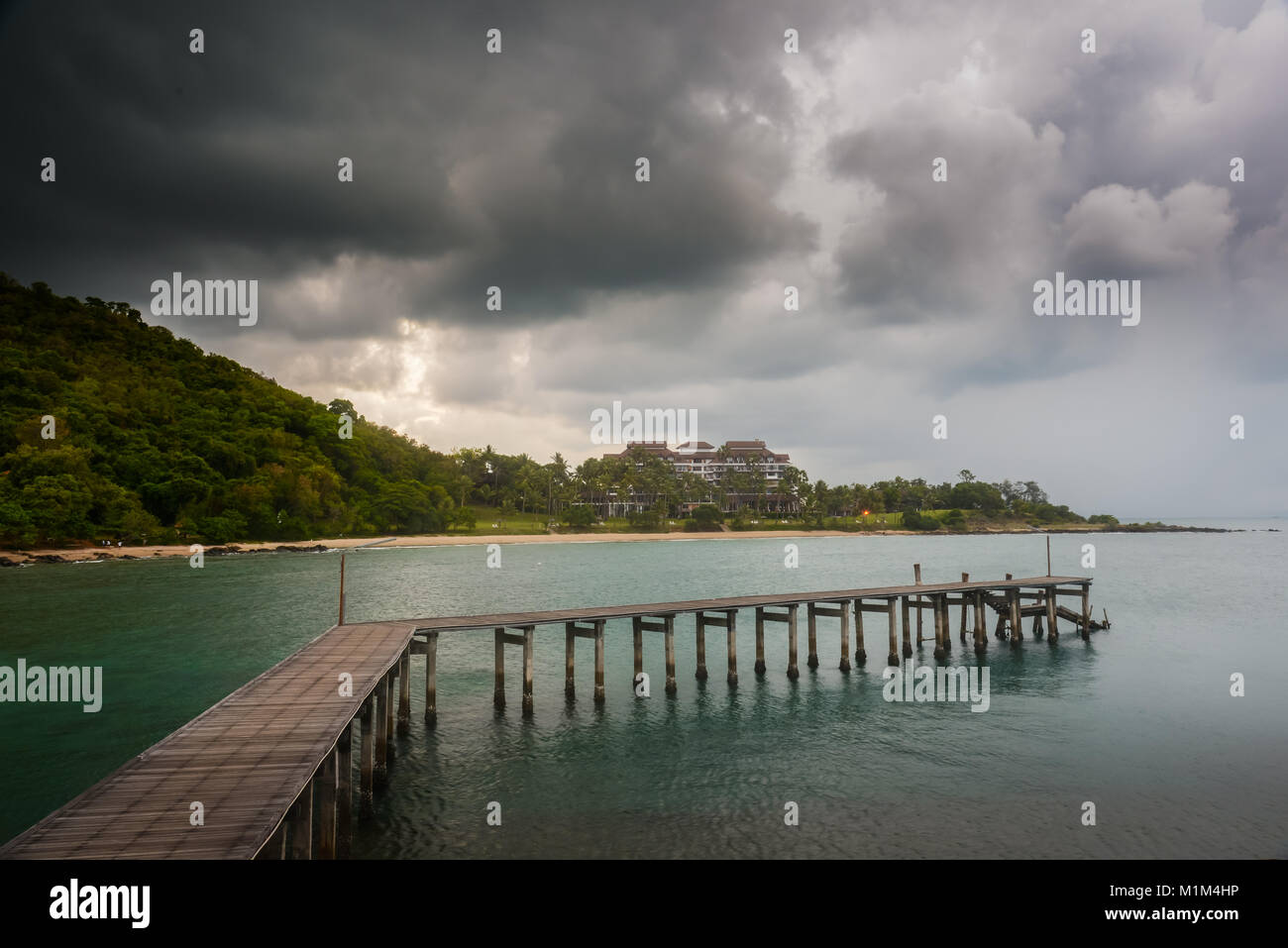 Wooden bridge on sea with rain clouds in public beach Stock Photo - Alamy