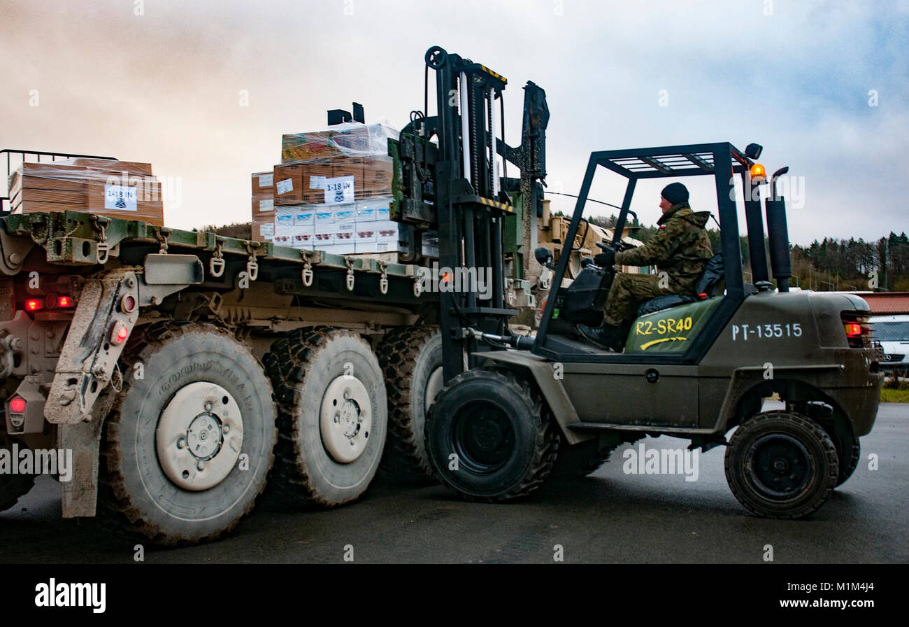 A Polish soldier uses a fork lift to load a pallet of Meals, Ready-to ...