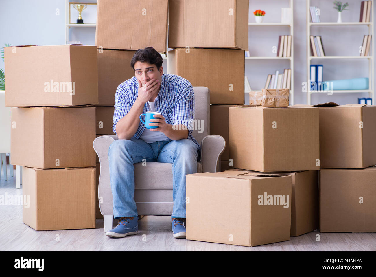 Young man moving in to new house with boxes Stock Photo - Alamy