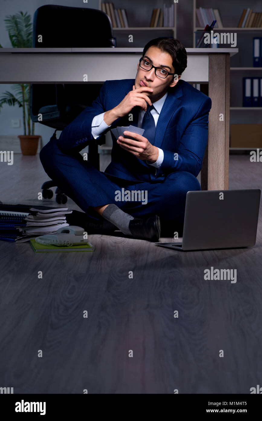 Businessman working overtime long hours late in office Stock Photo - Alamy