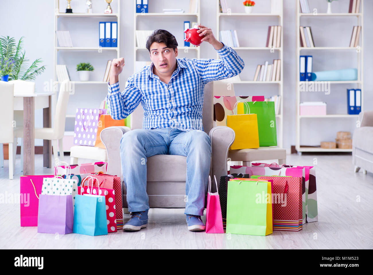Young man after excessive shopping at home Stock Photo - Alamy