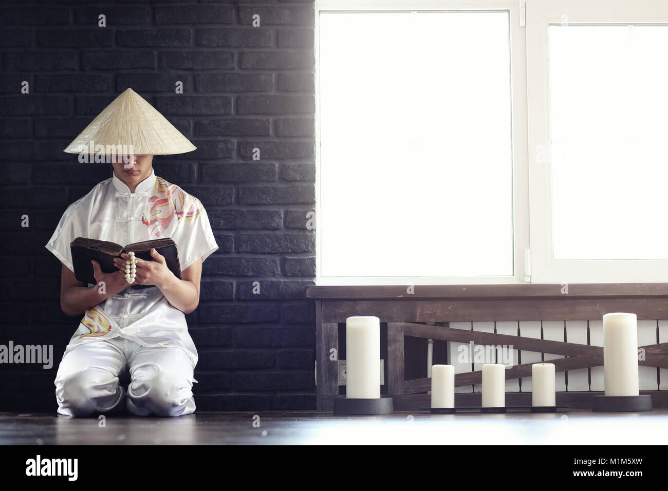Asian monk reading an old book Stock Photo - Alamy