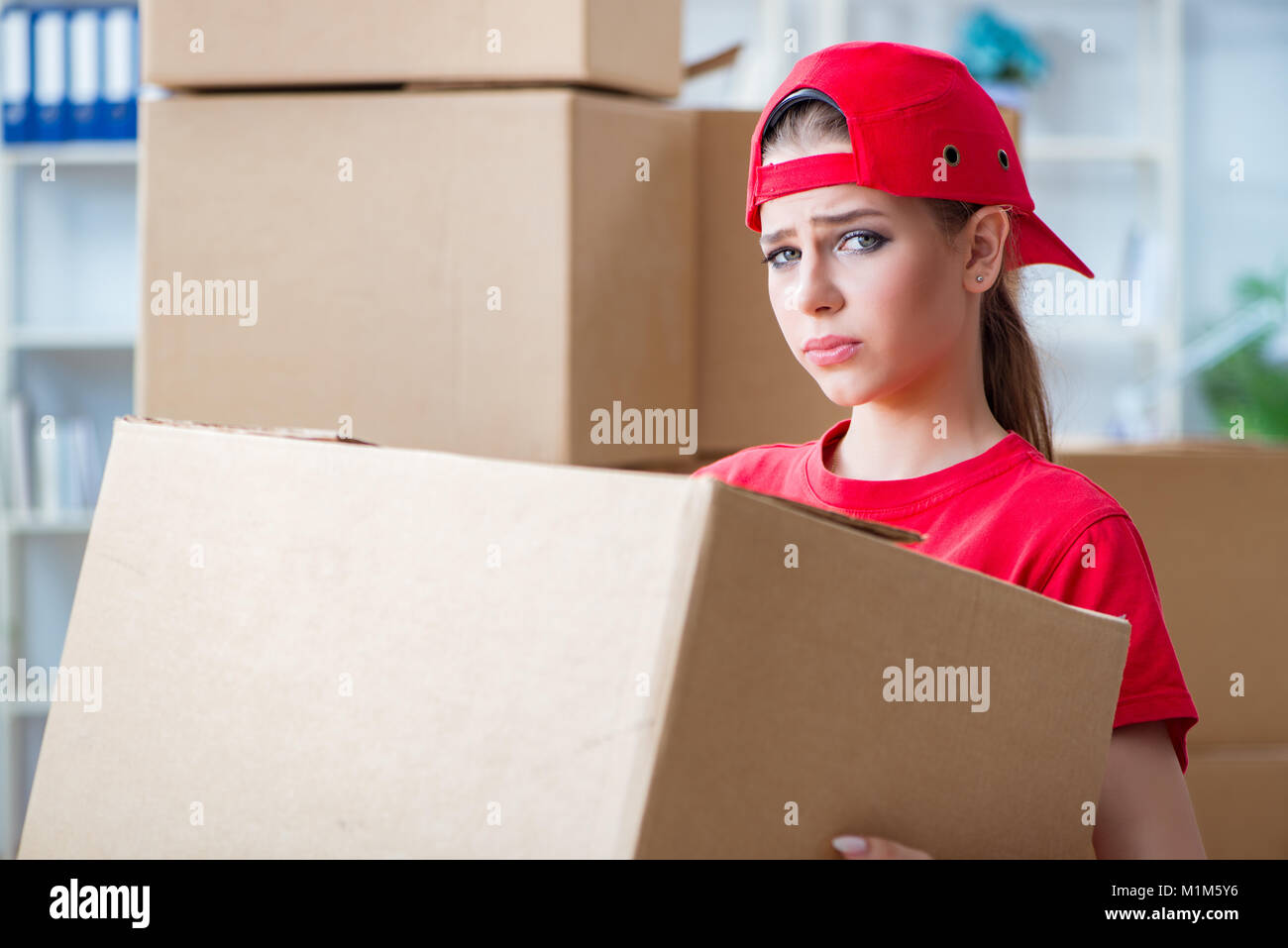 Young woman delivering boxes of personal effects Stock Photo - Alamy