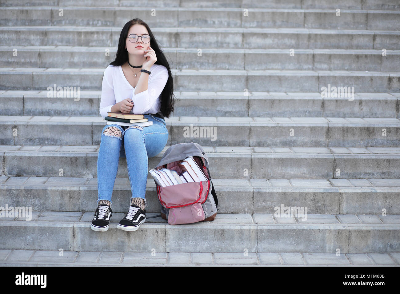 Girl student on the street with books Stock Photo - Alamy