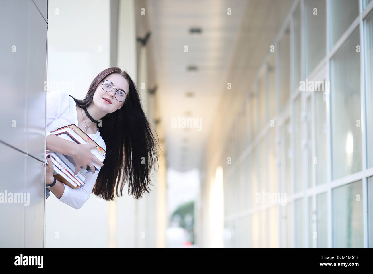 Girl student on the street with books Stock Photo - Alamy