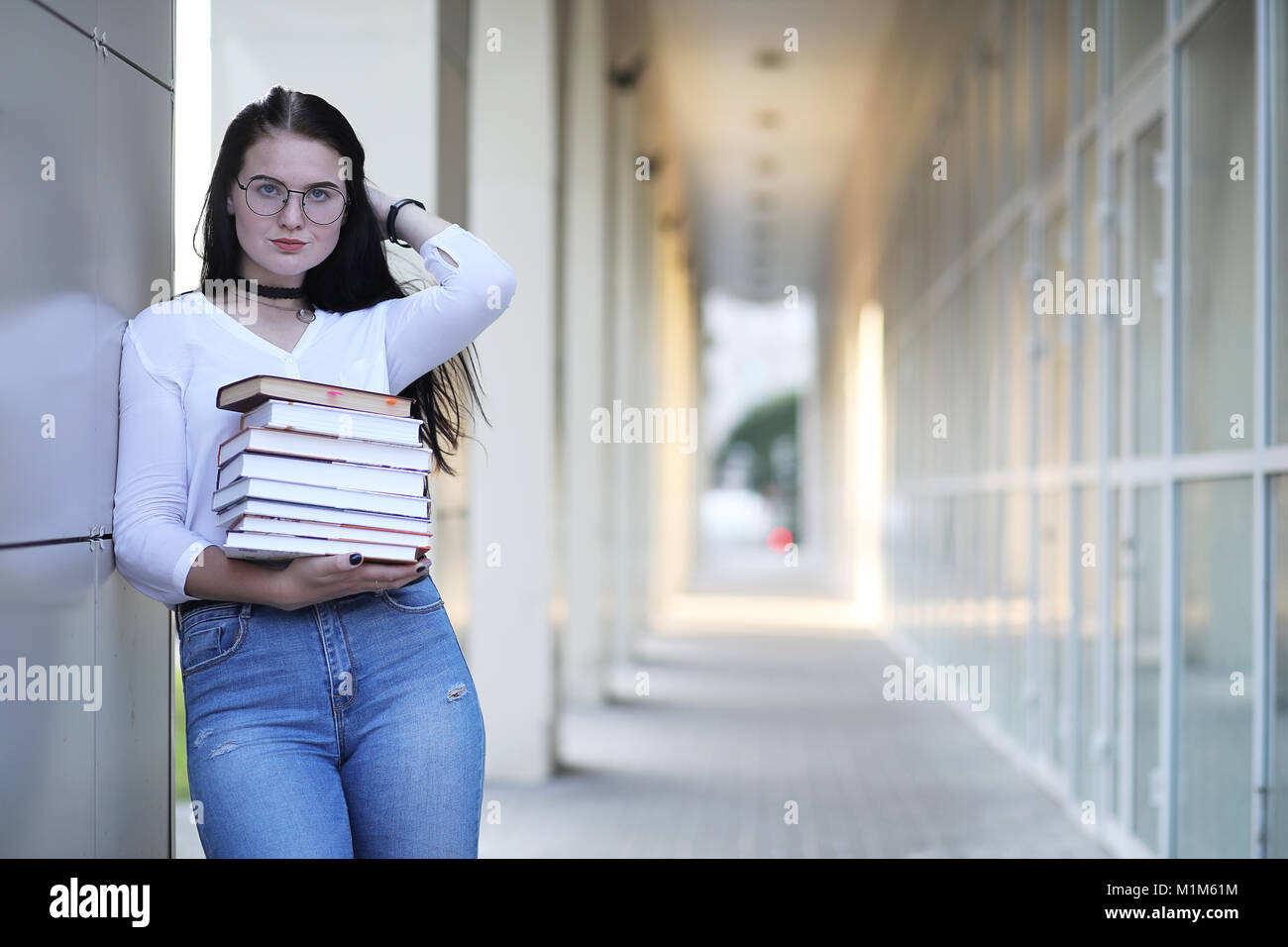 Girl student on the street with books Stock Photo - Alamy