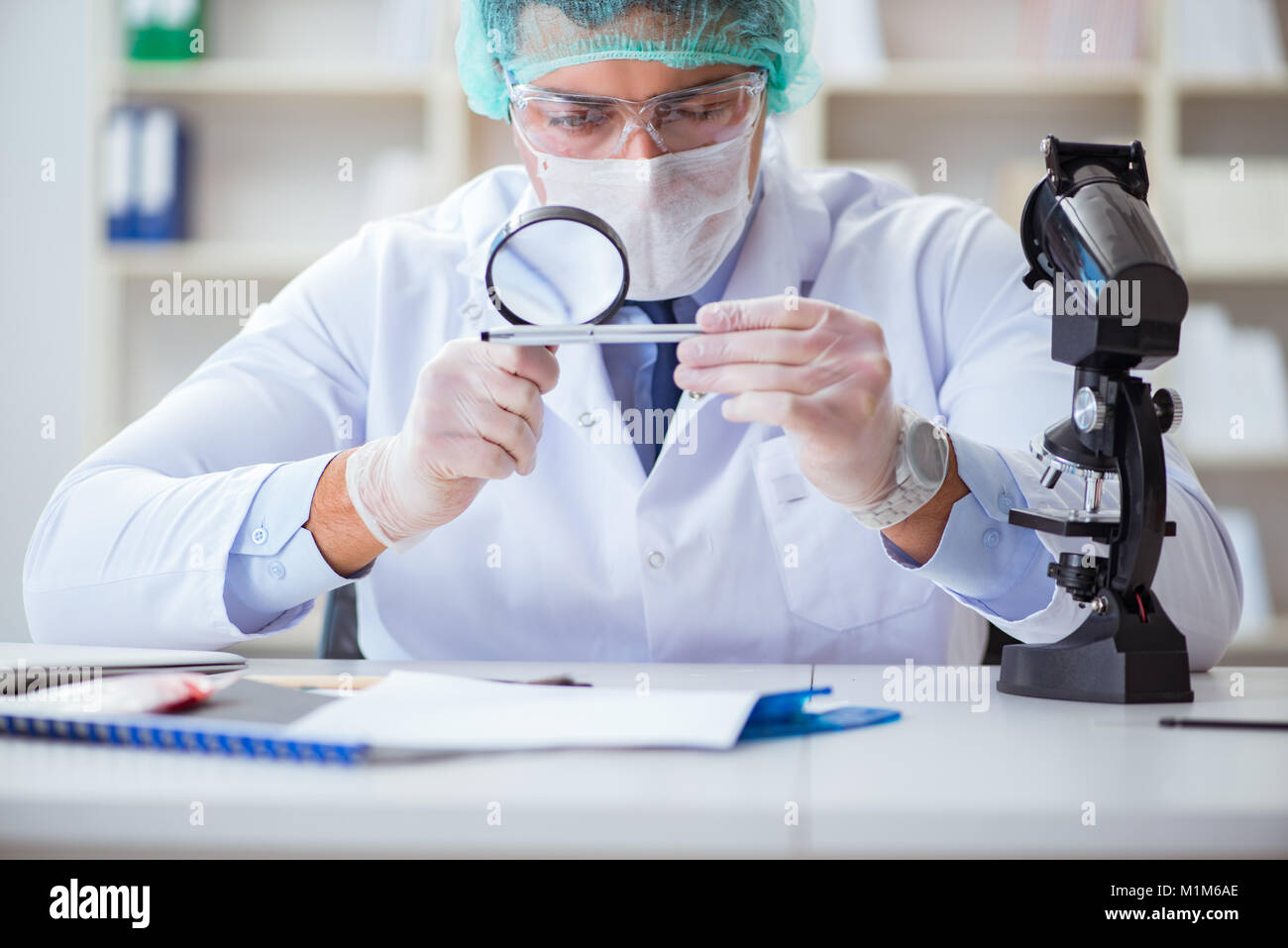 Forensics investigator working in lab on crime evidence Stock Photo - Alamy