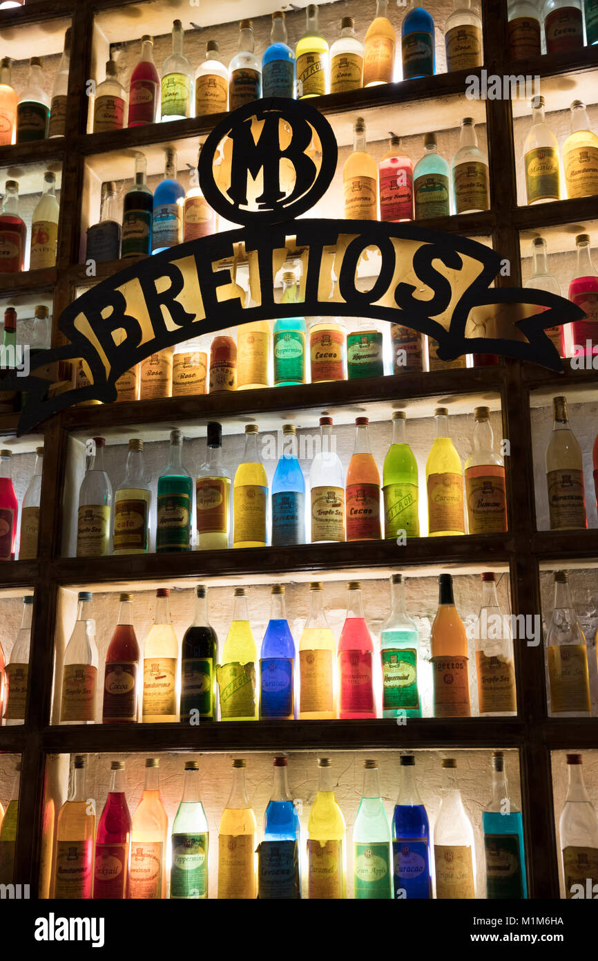 Colourful Ouzo bottles behind bar of Brettos, the oldest bar and ...