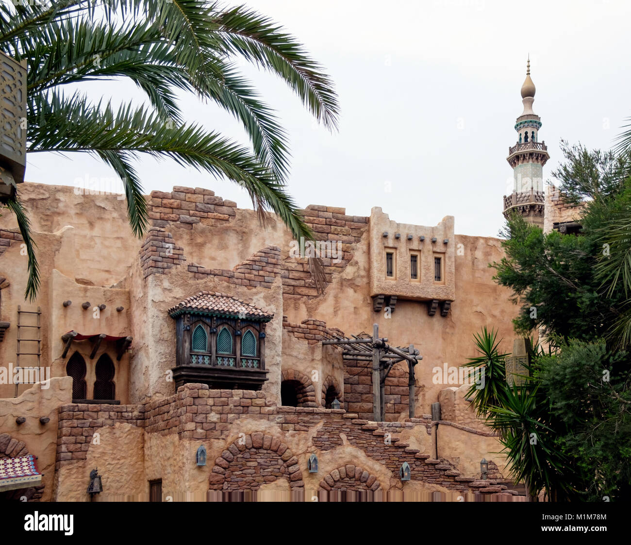 Arabic style buildings with arched windows, steps and a prayer tower in ...