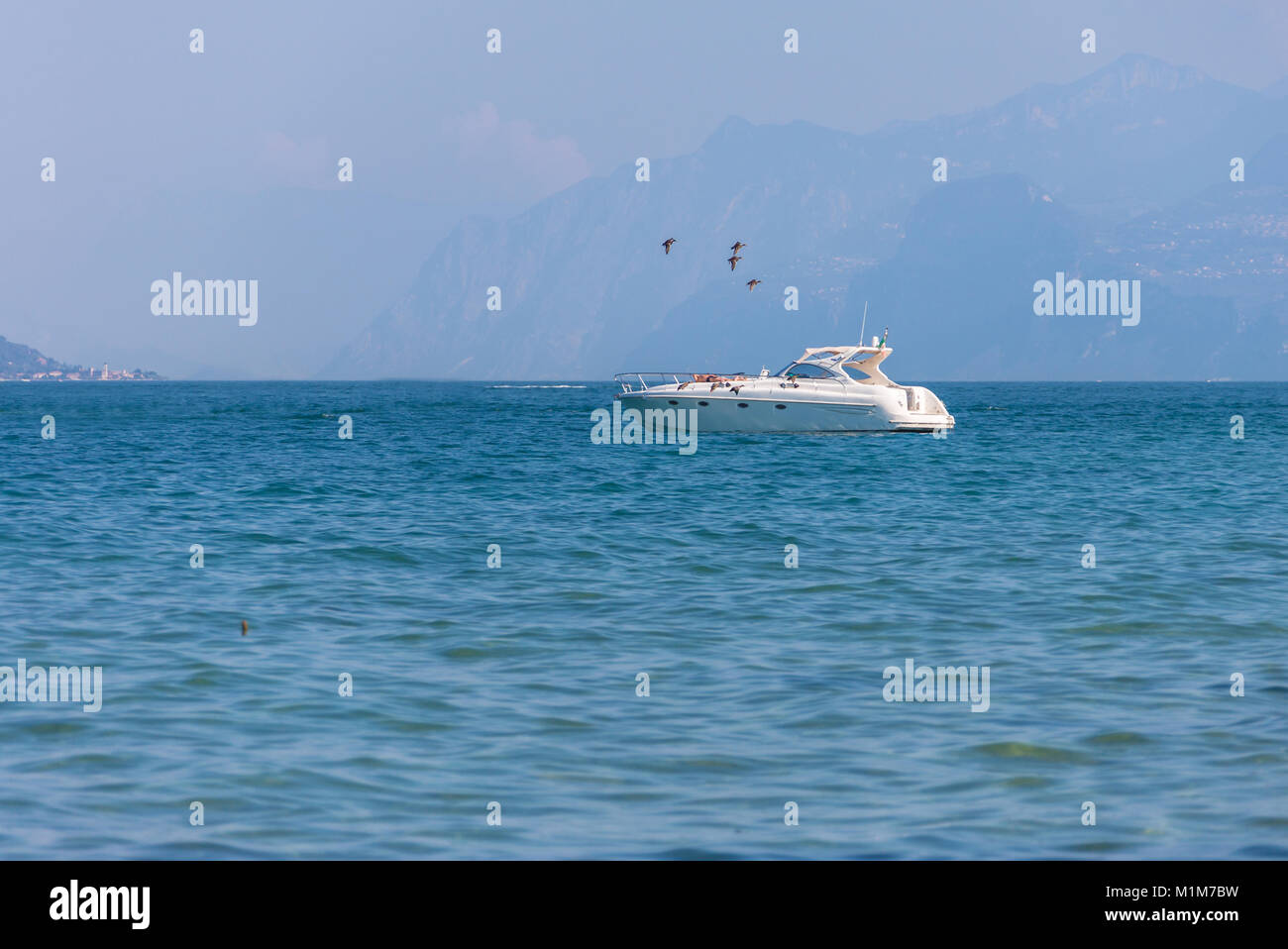 motor boat is floating along the coast Stock Photo - Alamy