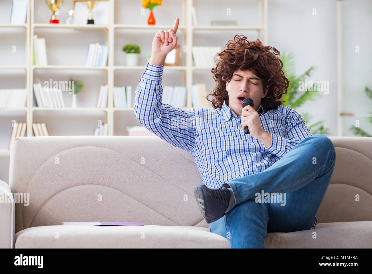 Funny man singing songs in karaoke at home Stock Photo - Alamy