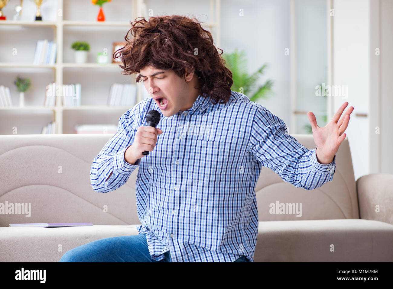 Funny man singing songs in karaoke at home Stock Photo - Alamy
