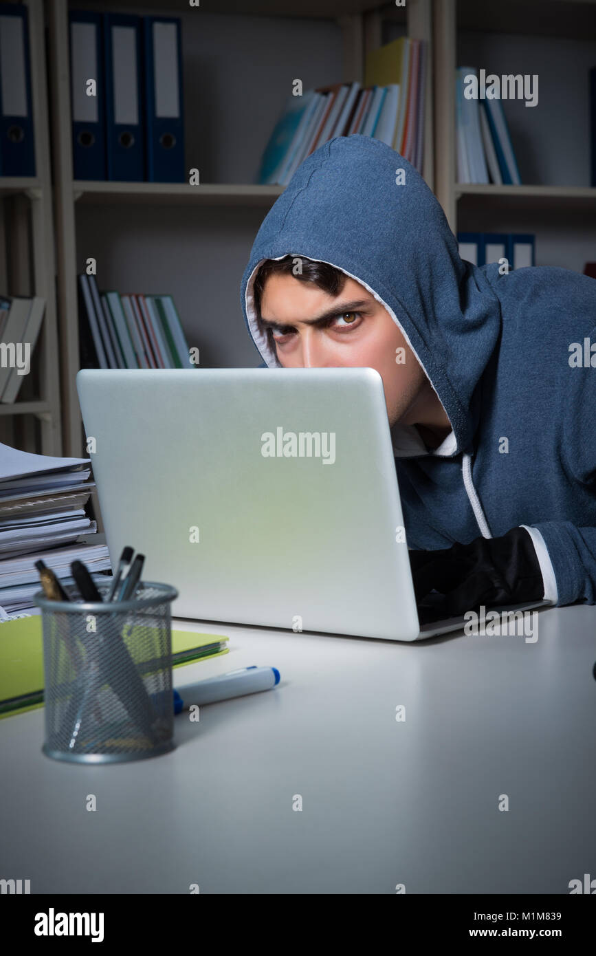 Young hacker hacking into computer at night Stock Photo - Alamy