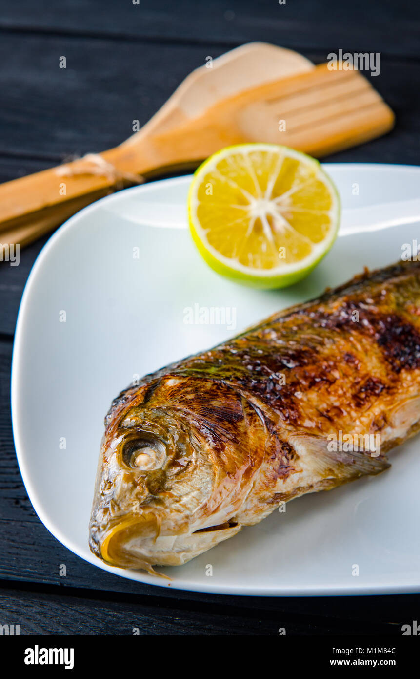 Fried fish served on the plate Stock Photo - Alamy