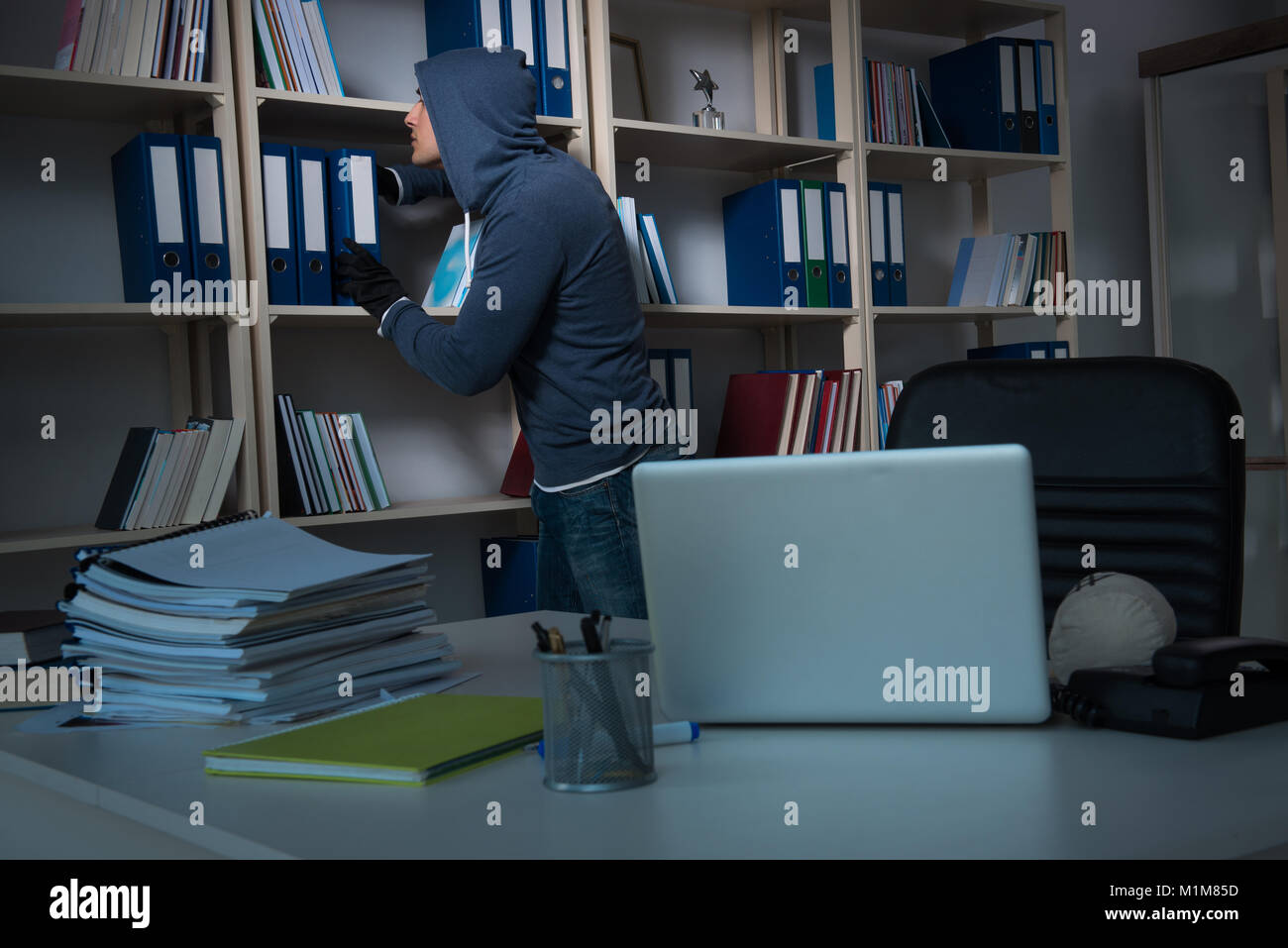 Young man in industrial espionage concept Stock Photo - Alamy