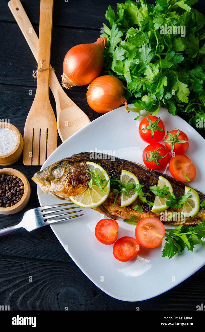 Fried fish served on the plate Stock Photo - Alamy