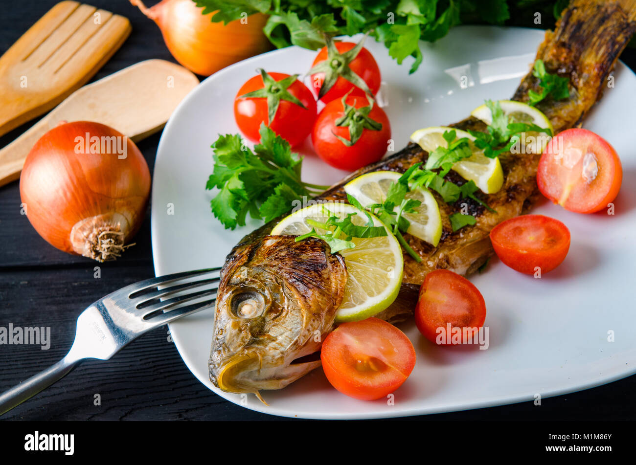 Fried fish served on the plate Stock Photo - Alamy