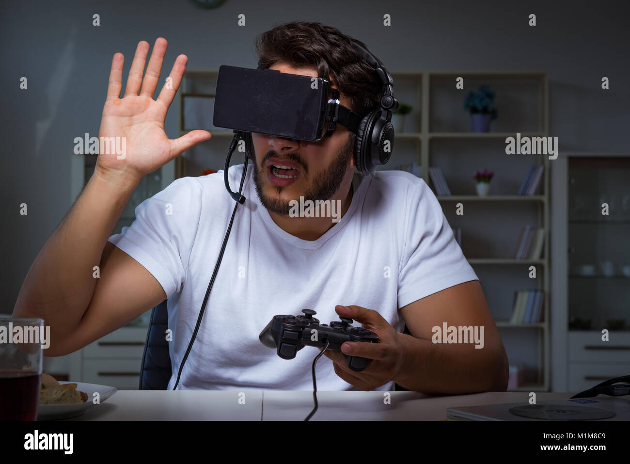 Young man playing games long hours late in the office Stock Photo - Alamy