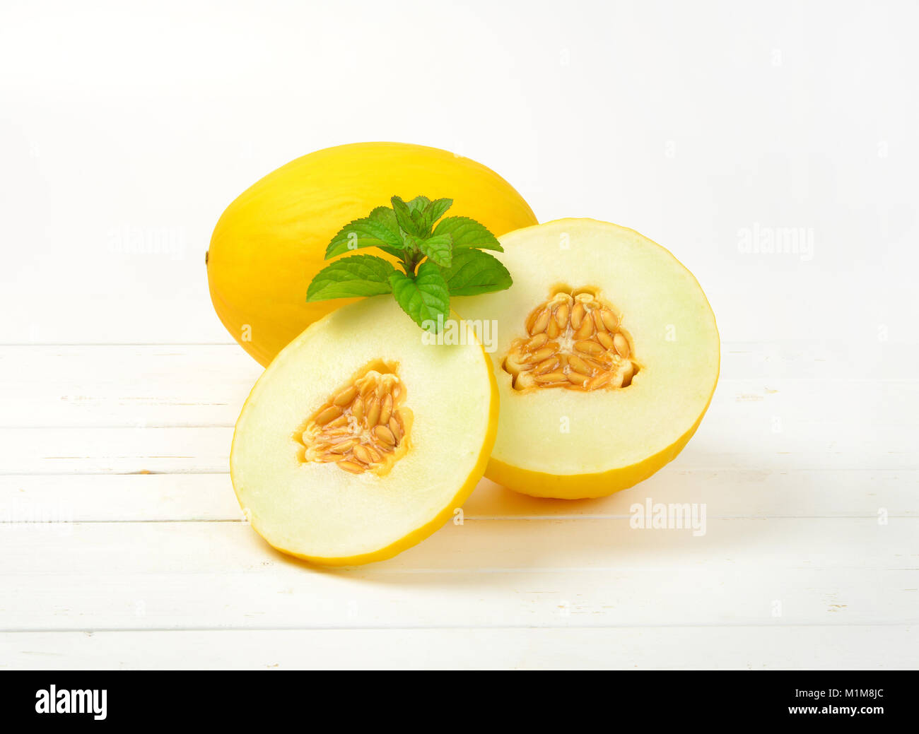 fresh yellow melons - whole, half and slice Stock Photo - Alamy