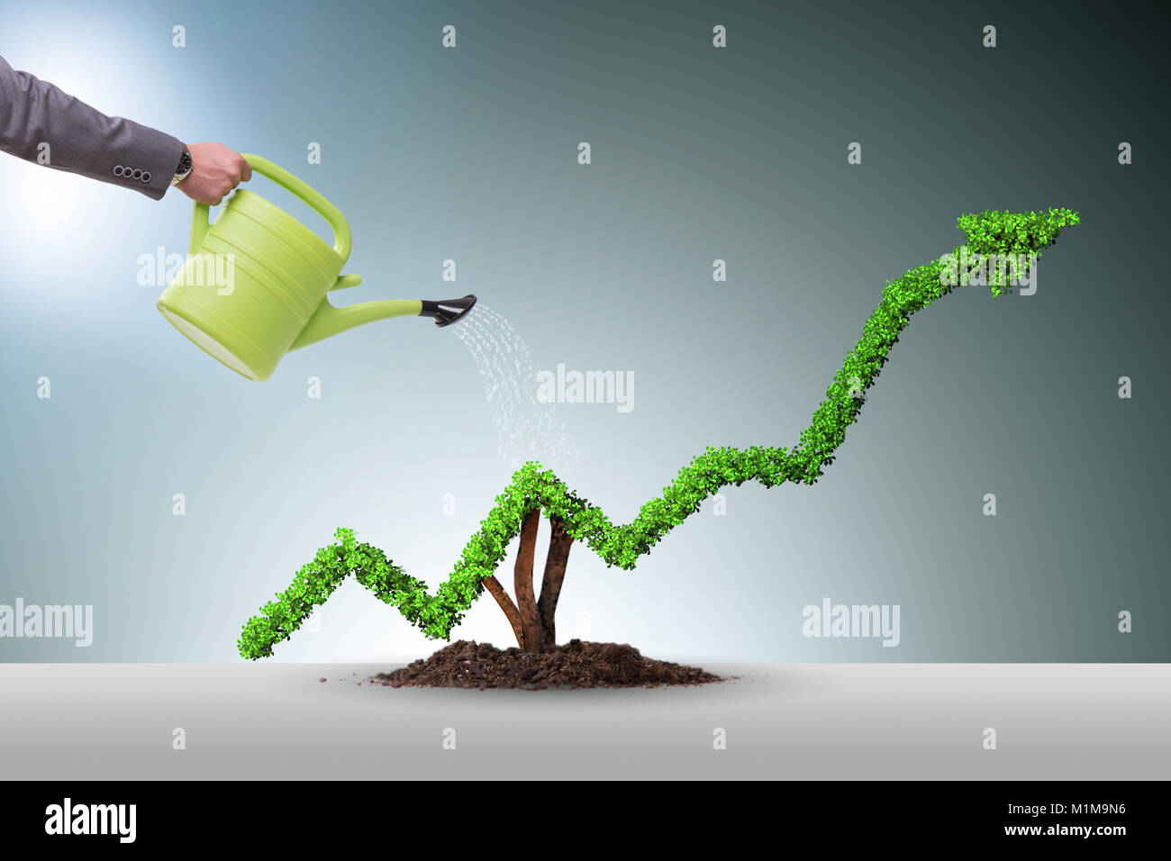 Businessman in investment concept watering financial line chart Stock ...