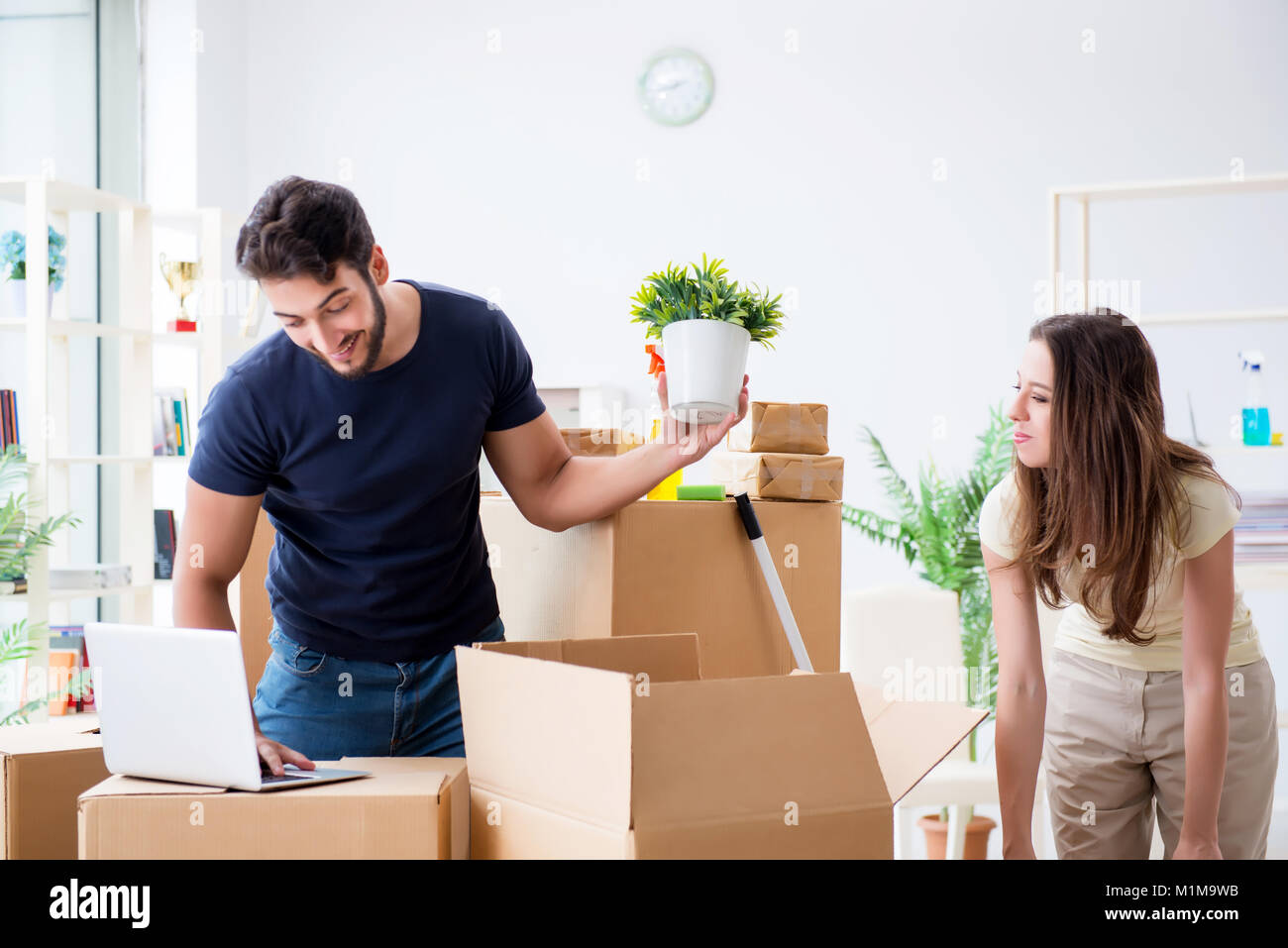 Young family unpacking at new house with boxes Stock Photo - Alamy