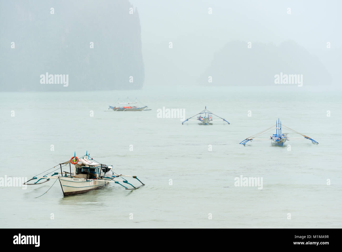 Double-outrigger boats in the harbour of El Nido, Palawan, the ...