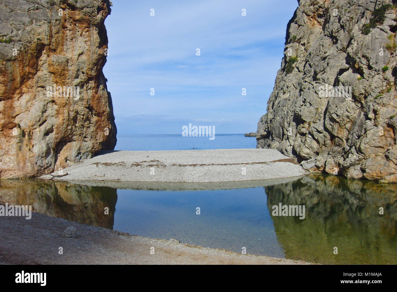 small island with a gateway to the sea from cliffs Stock Photo - Alamy