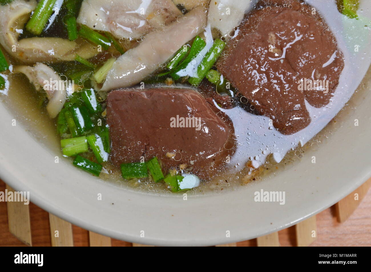 boiled pork blood with entrails in soup Stock Photo - Alamy