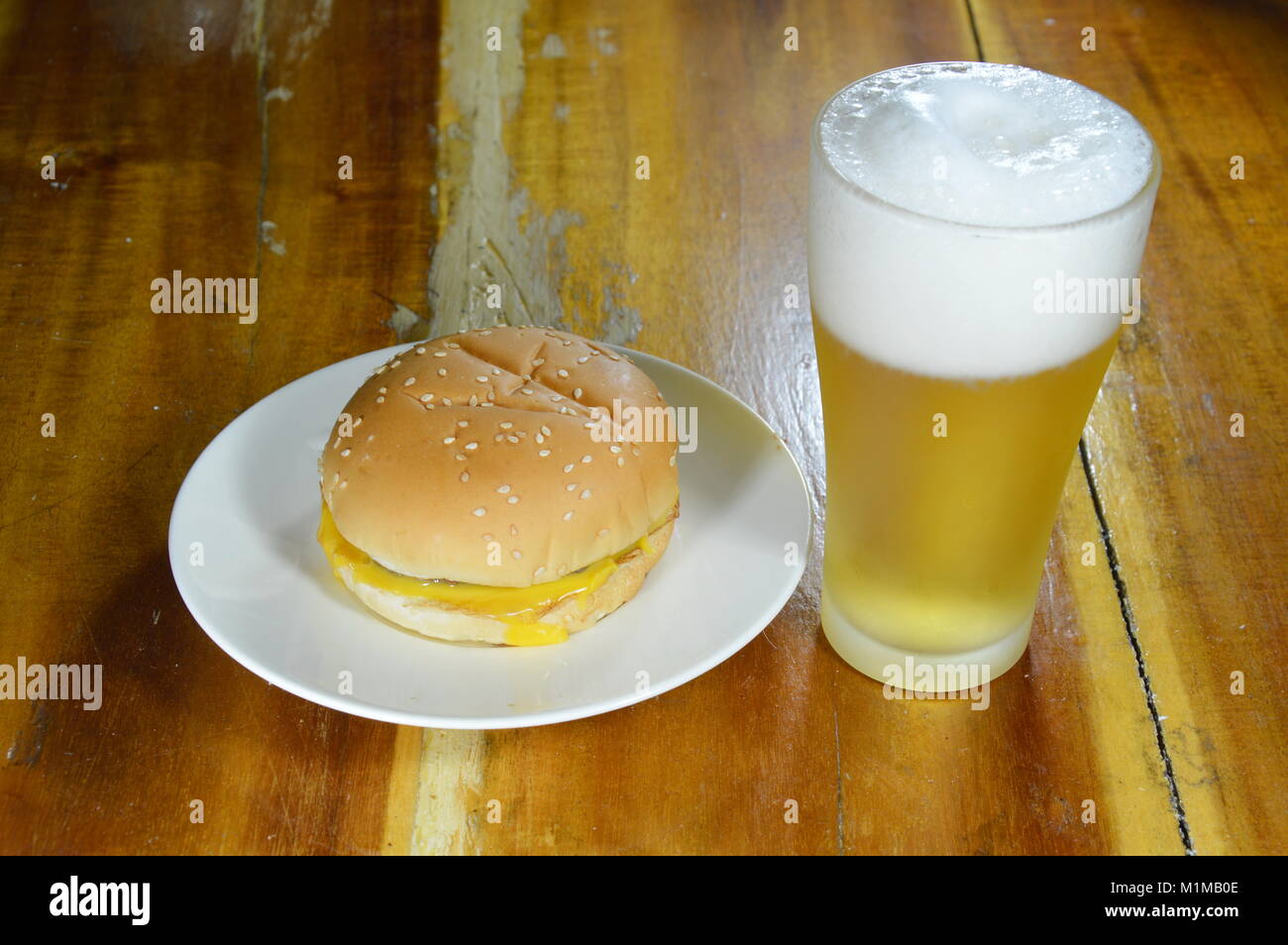 cheeseburger and beer on table Stock Photo - Alamy