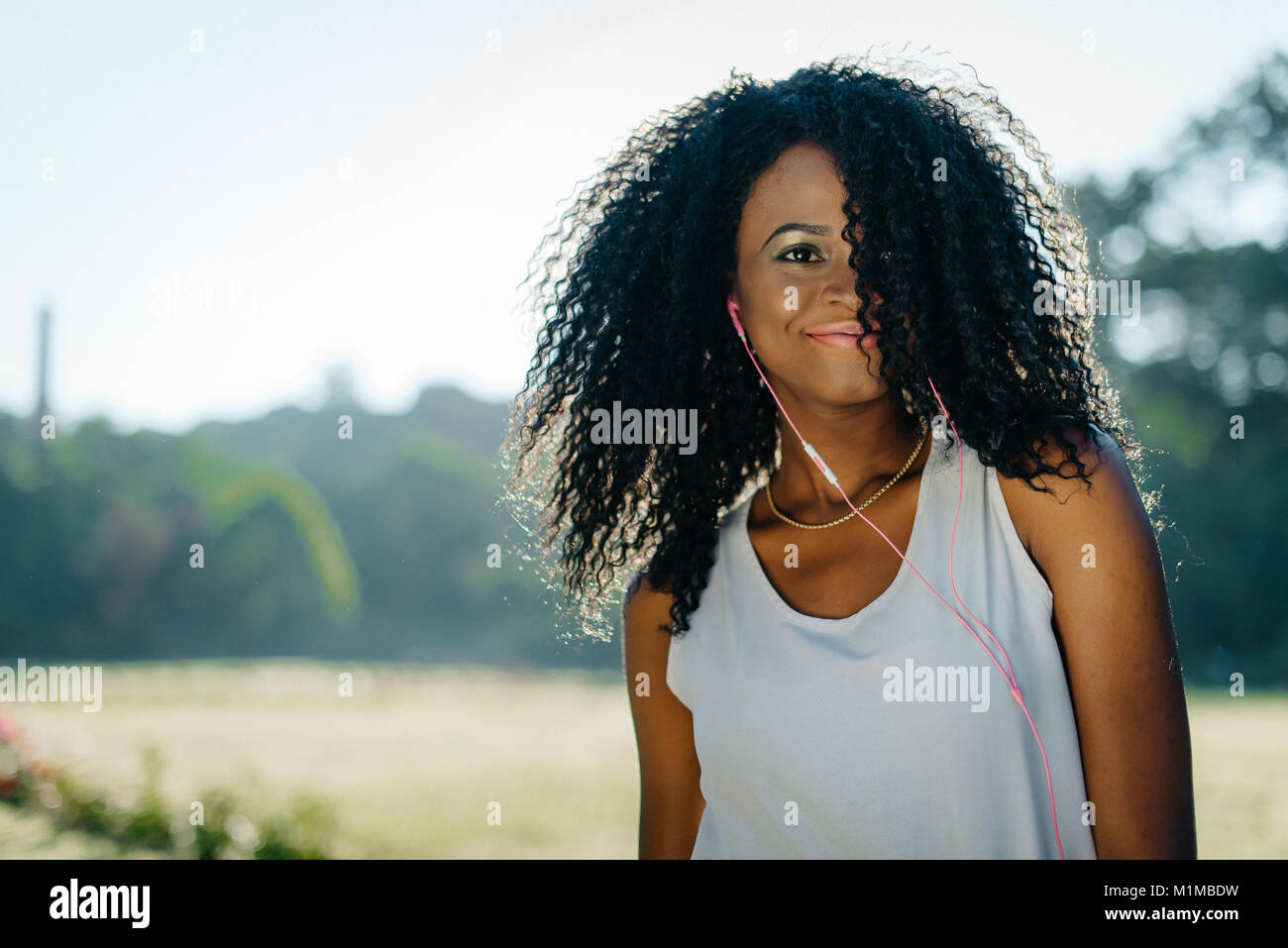 Outdoor portrait of the adorable african girl with green eye shadows ...