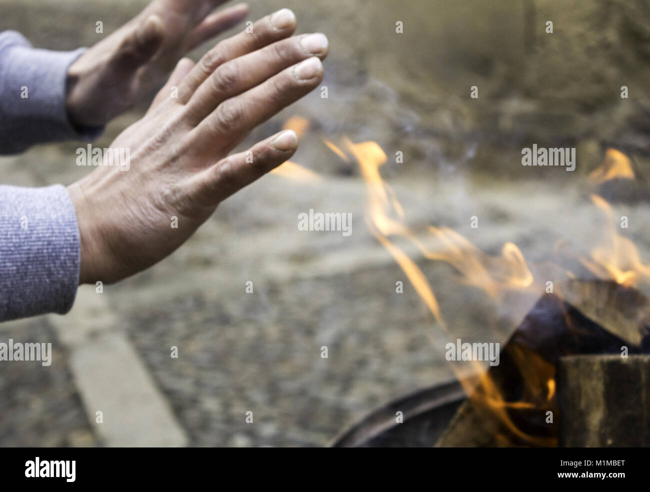Beggar in winter bonfire warming, poverty and homeless Stock Photo - Alamy