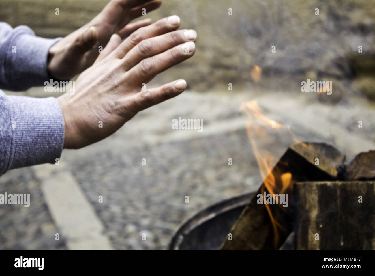 Beggar in winter bonfire warming, poverty and homeless Stock Photo - Alamy