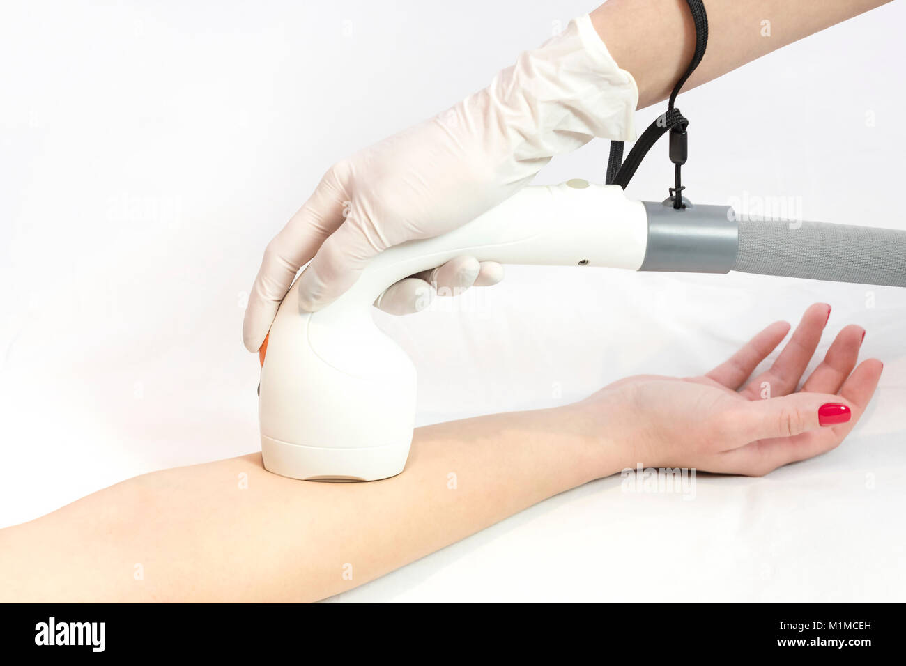 The process of laser depilation of female limbs in the beauty salon ...