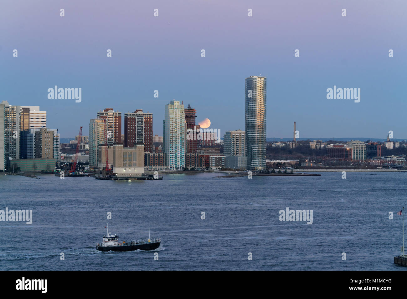 A lunar eclipse over the Hudson River as seen from Tribeca in Manhattan ...