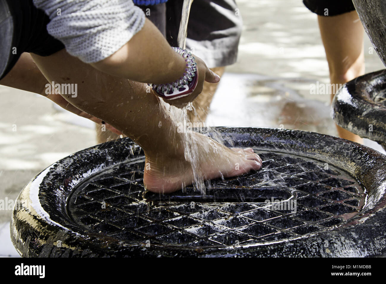 Washing feet in fountain after harvesting, hygiene and cleaning Stock ...