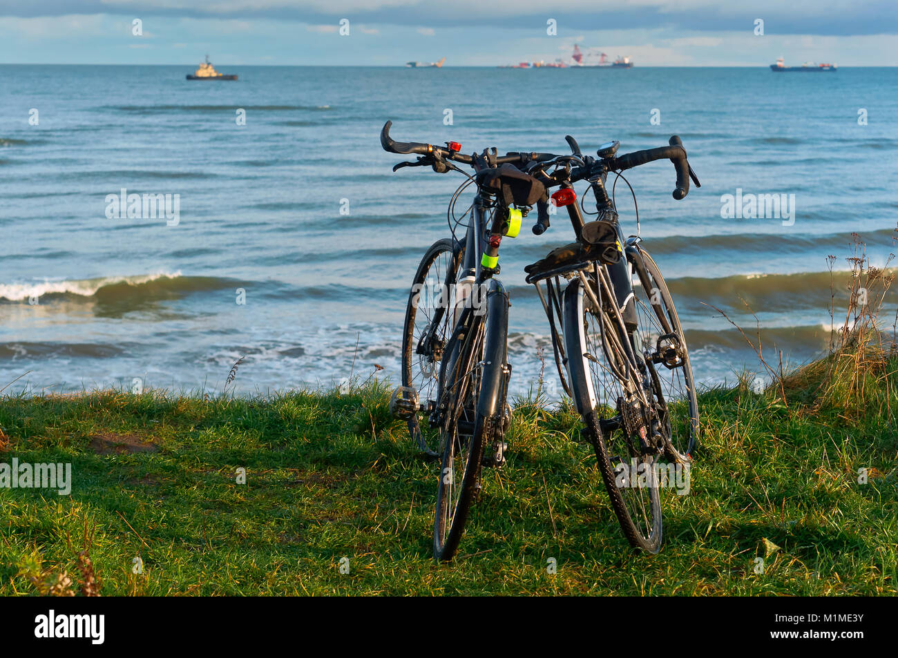two bikes on the beach, two bikes on the coast Stock Photo - Alamy