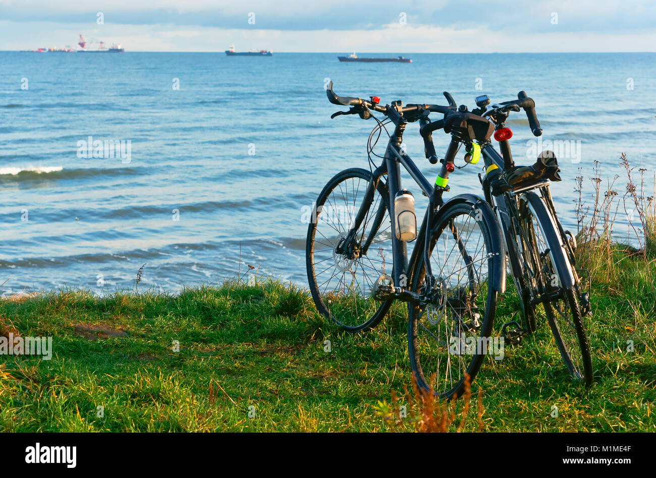 two bikes on the beach, two bikes on the coast Stock Photo - Alamy