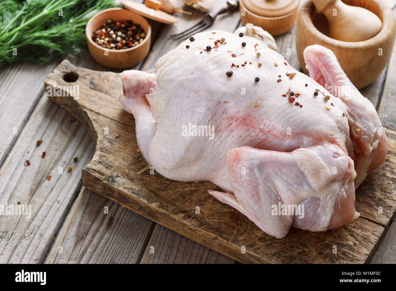 chicken carcass on a wooden background with spices, cooking in the ...
