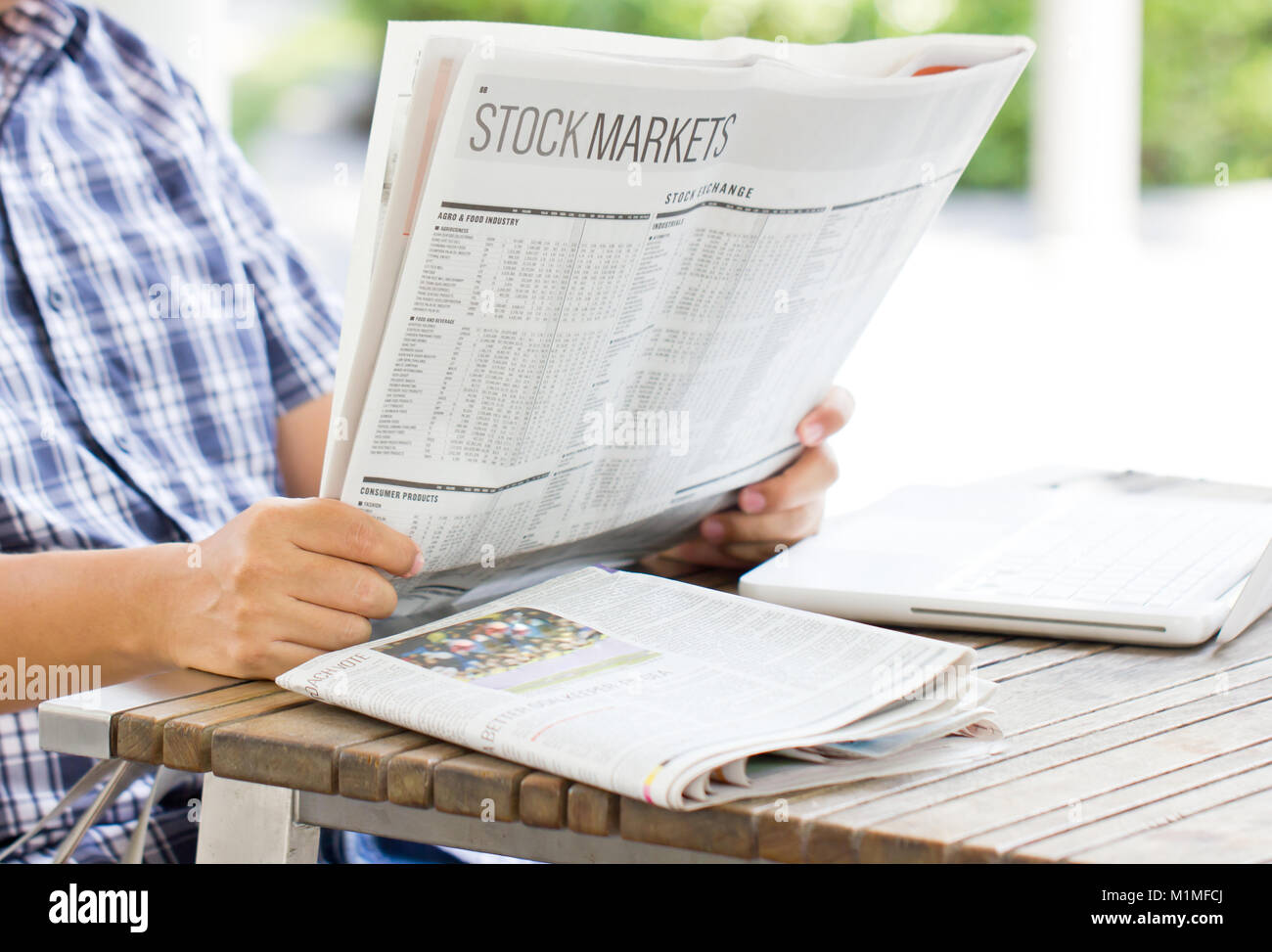 Asian man reading the financial newspaper Stock Photo - Alamy