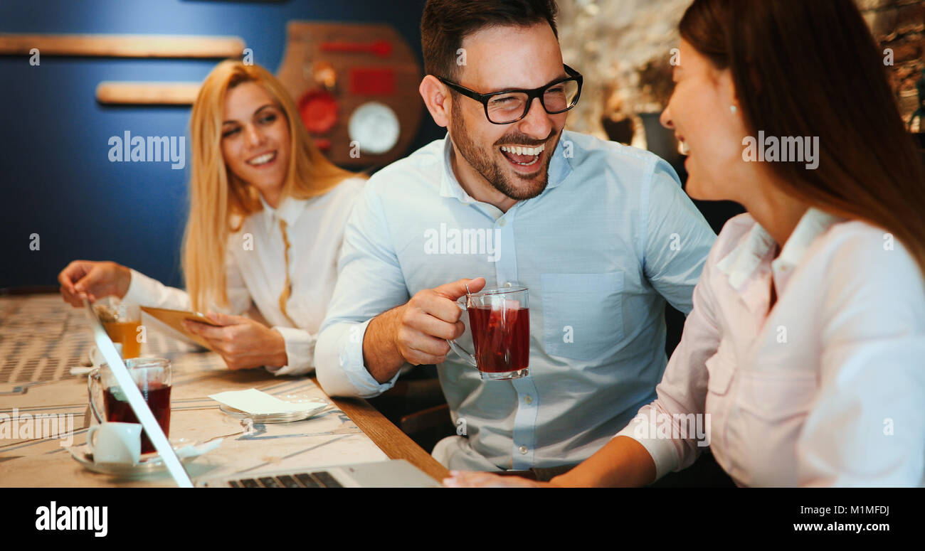 Happy colleagues from work socializing in restaurant Stock Photo - Alamy