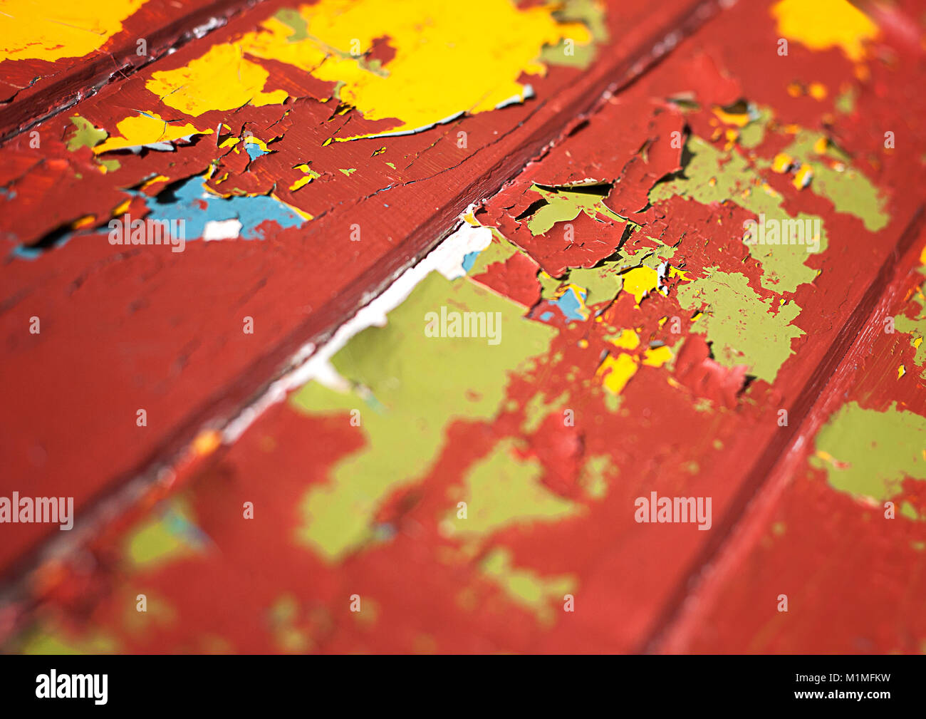 Old peeling paint revealing different layers of coloured paint on ...