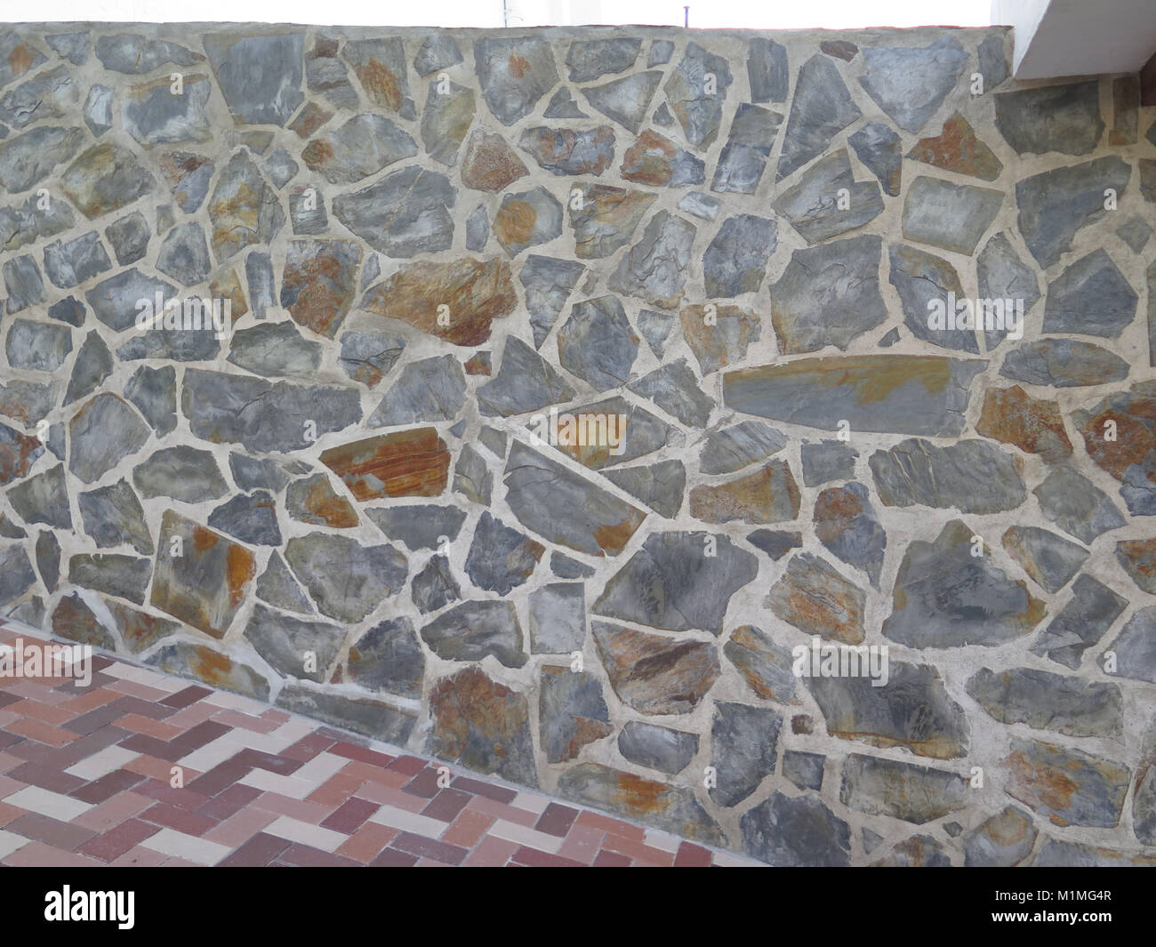 Stone clad wall and newly laid pavement in andalusian village Stock ...