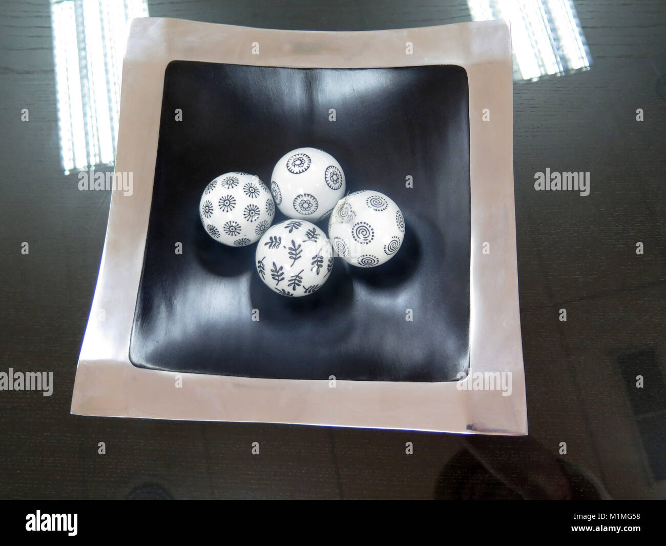 Square bowl with round decorative ceramic balls Stock Photo - Alamy