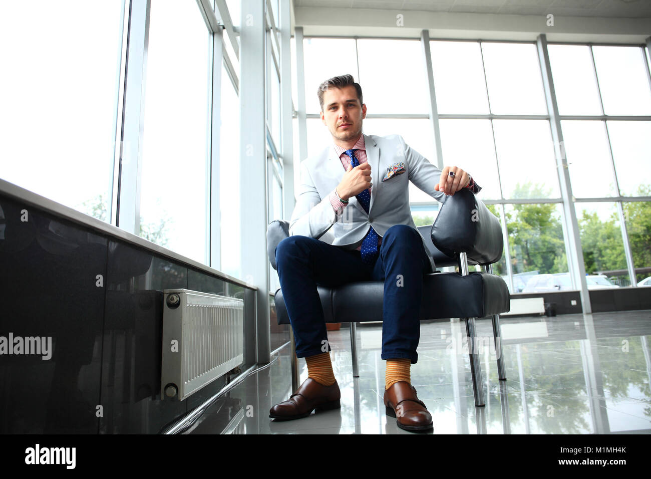 Low angle shot of a handsome young businessman in a stylish modern ...