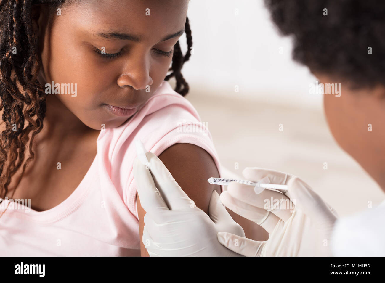 Doctor Applying Injection To African Girl In Clinic Stock Photo - Alamy