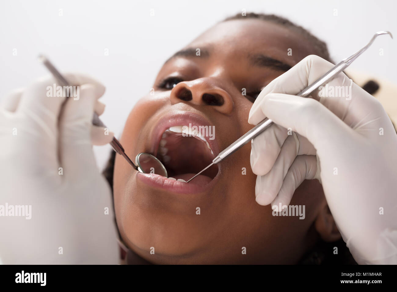 Dentist Examining A African Girls' Teeth In The Clinic Stock Photo - Alamy